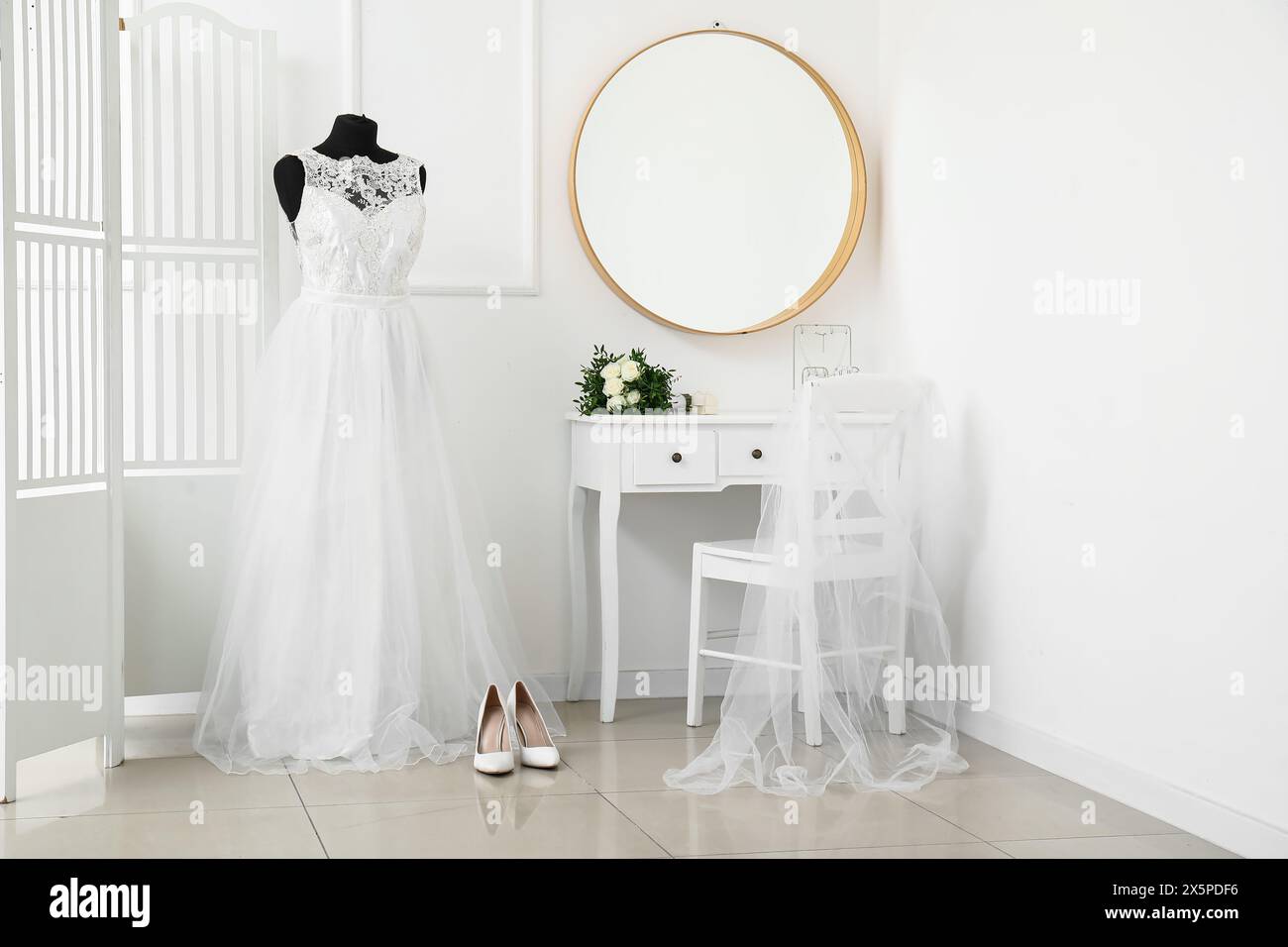 Mannequin with wedding dress and wedding bouquet on white dressing ...