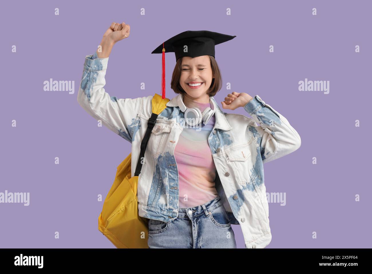 Happy female student in graduation hat on lilac background Stock Photo ...