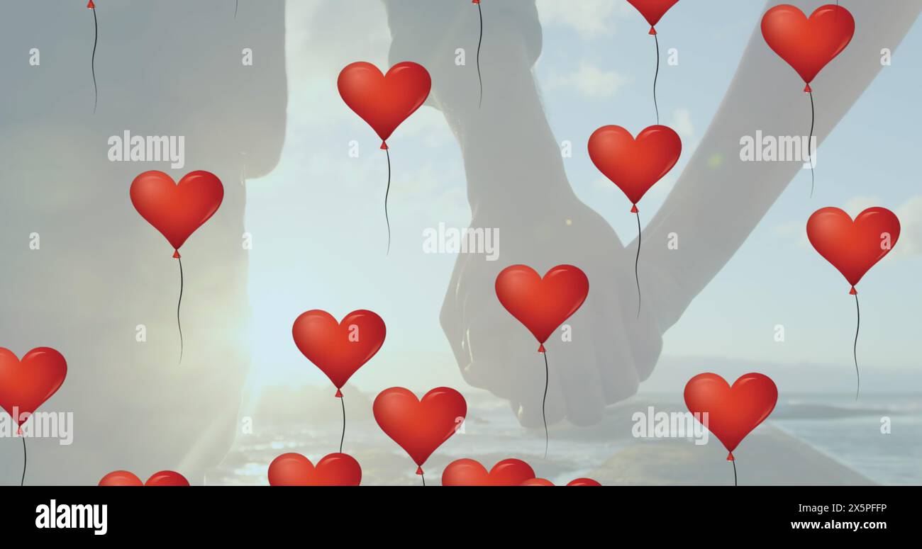 Two hands are holding each other surrounded by floating red heart ...