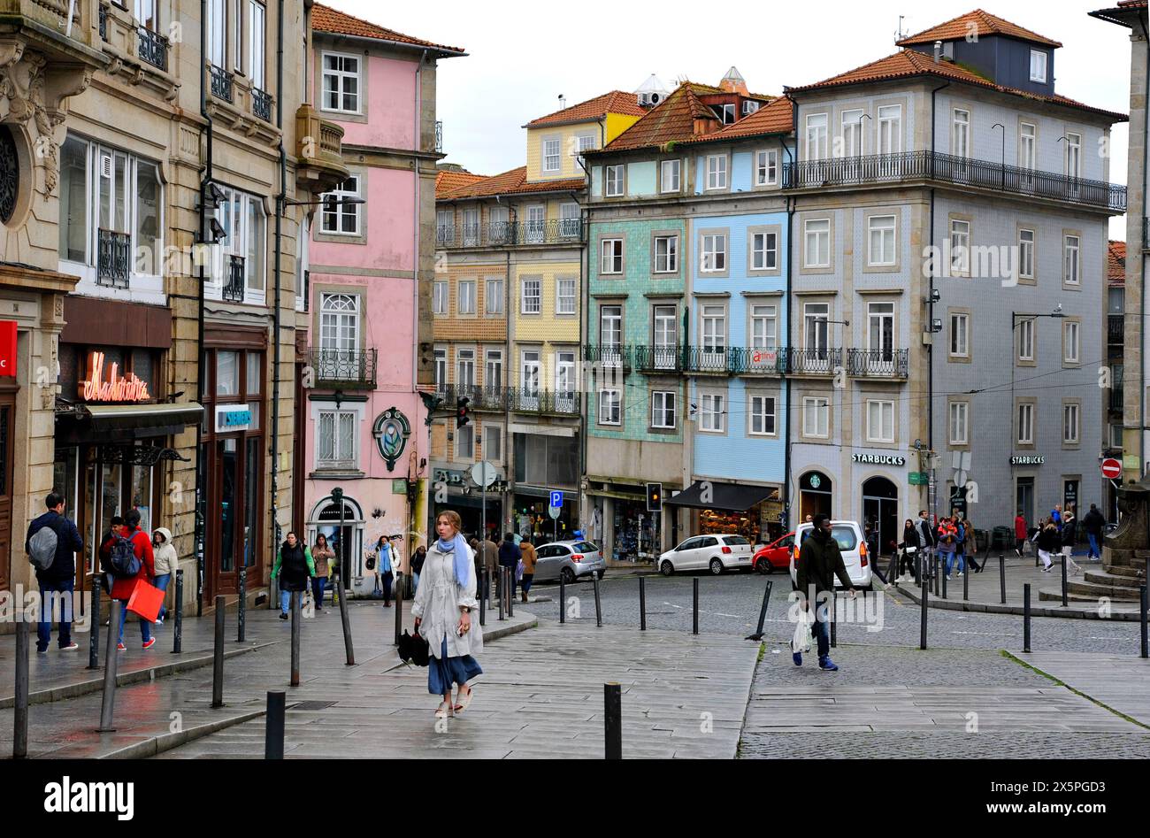 People walking in colorful streets on a rainy day in Porto, Portugal ...