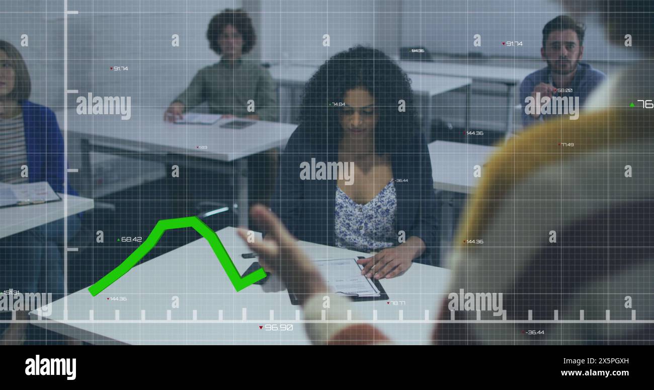 Image of green graphs moving over african american woman taking notes ...