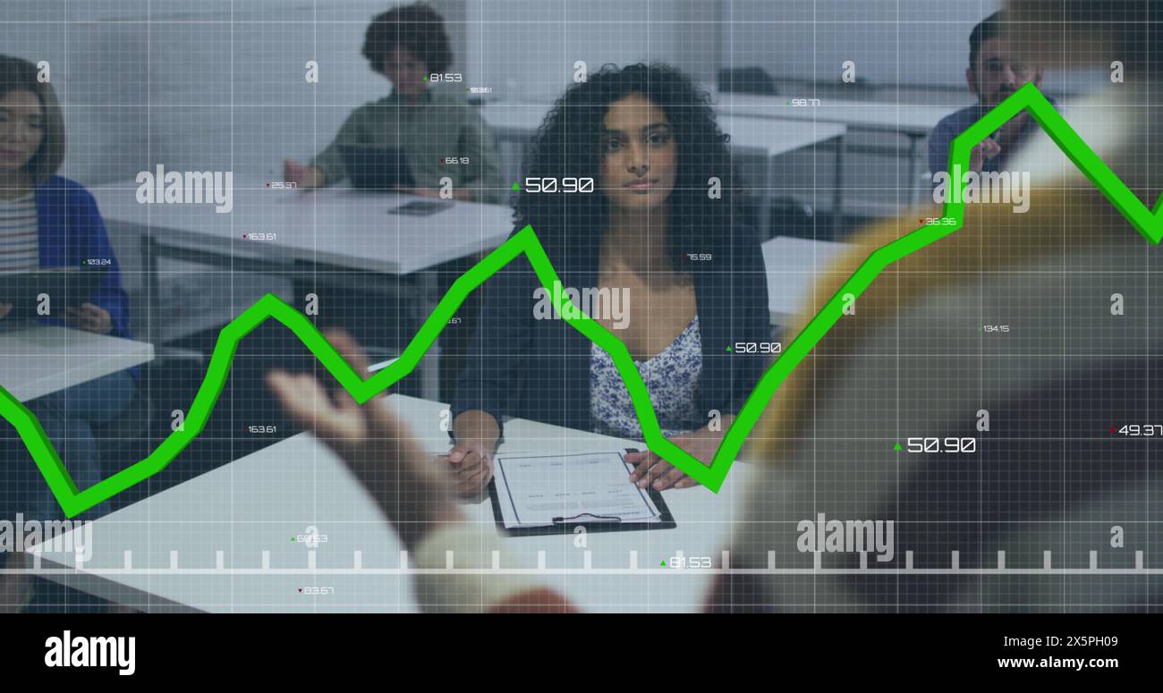 Image of green graphs moving over african american woman taking notes ...