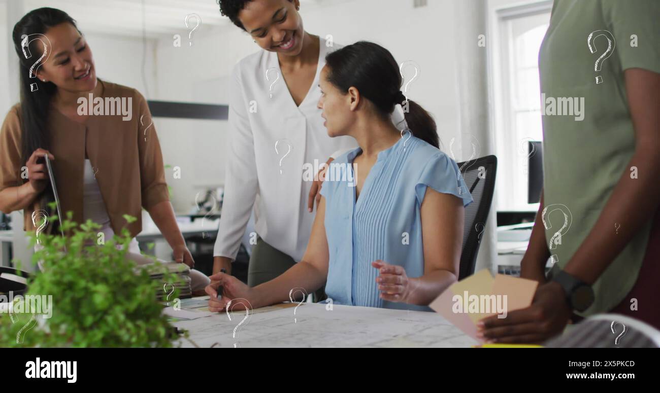 Image of question mark symbols over multiracial coworkers discussing in ...