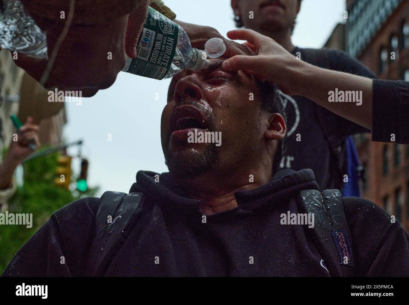 New York, New York, USA. 9th May, 2024. A man is sprayed in the eyes ...
