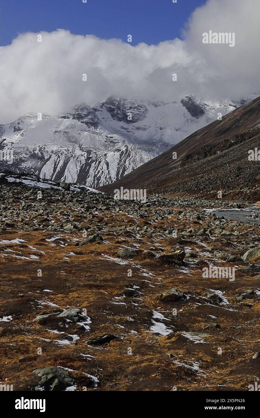 scenic landscape of alpine tundra valley and cloud covered snowcapped ...