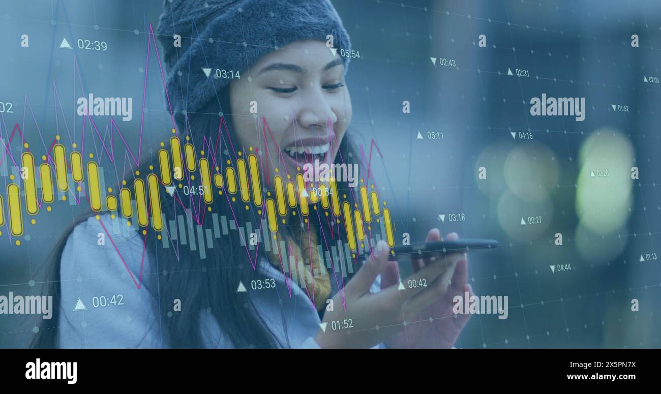 Image of graphs and changing numbers, smiling biracial woman talking on ...