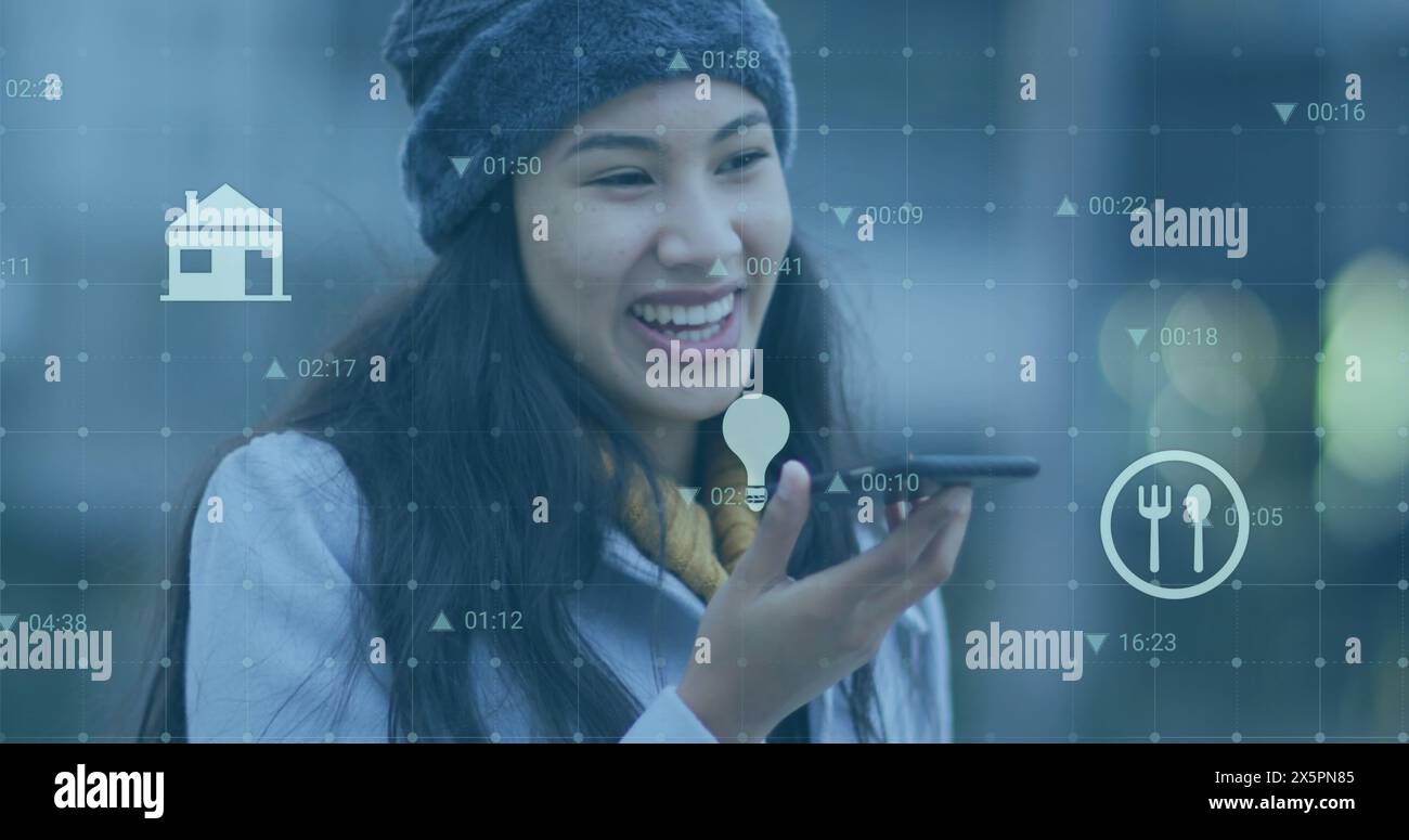 Image of icons and changing numbers, smiling biracial woman talking on ...