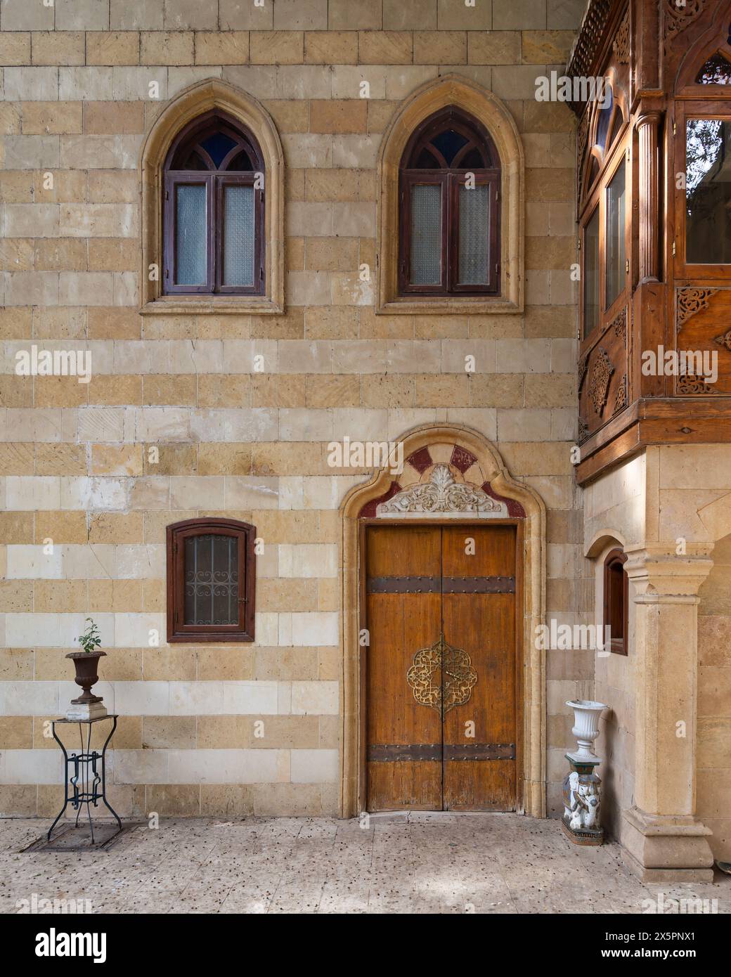 A Mamluk style stone facade featuring a richly decorated wooden door ...