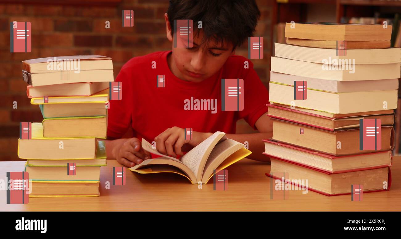 Image of books moving over schoolboy reading book Stock Photo - Alamy
