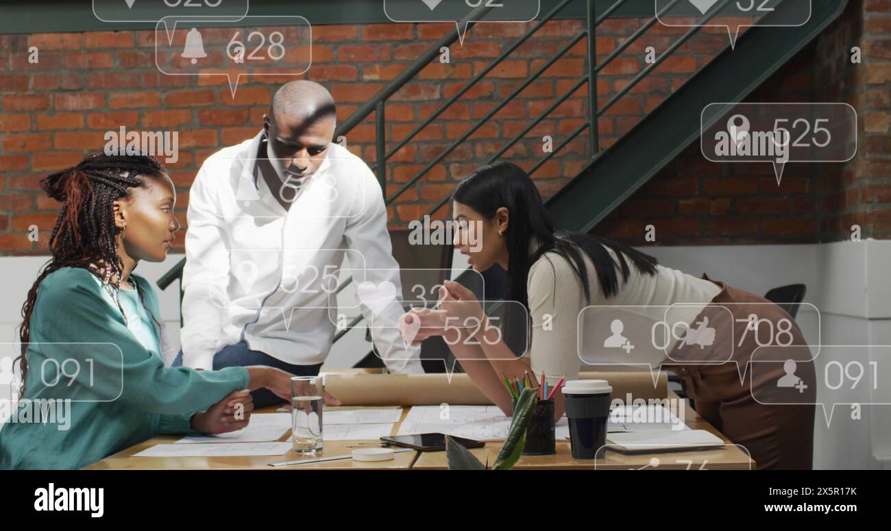 Anmation of social media icons floating over diverse colleagues ...