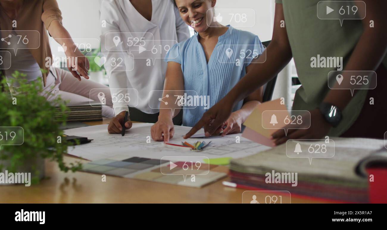 Anmation of social media icons floating over diverse colleagues ...