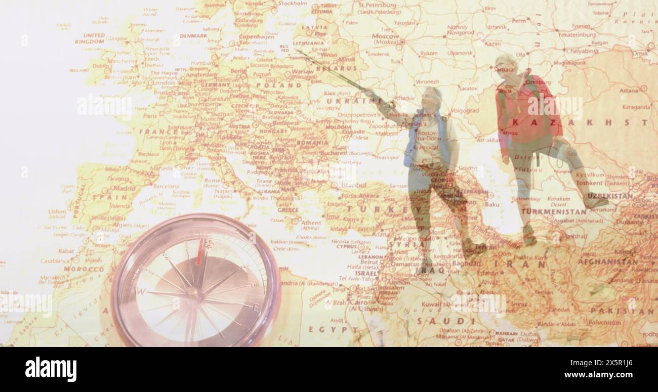 Caucasian couple exploring map of Europe and Asia, compass in ...
