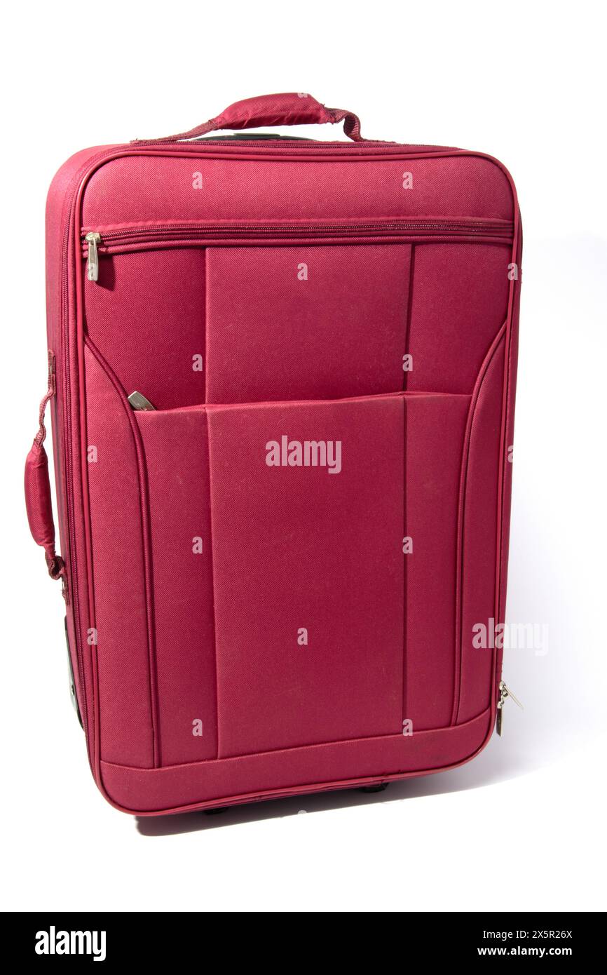 Closed red suitcase isolated on white background with empty space for ...