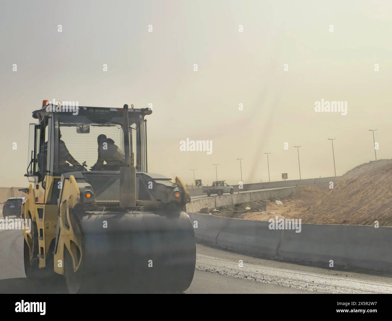 Cairo, Egypt, March 27 2024: process of paving a road and making ...