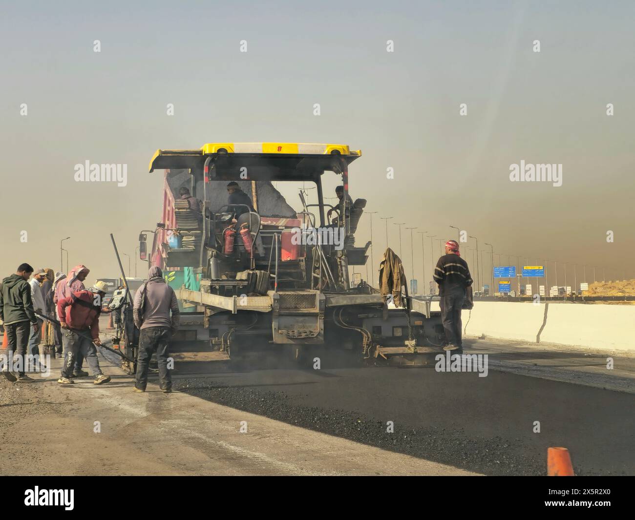Cairo, Egypt, March 27 2024: process of paving a road and making ...