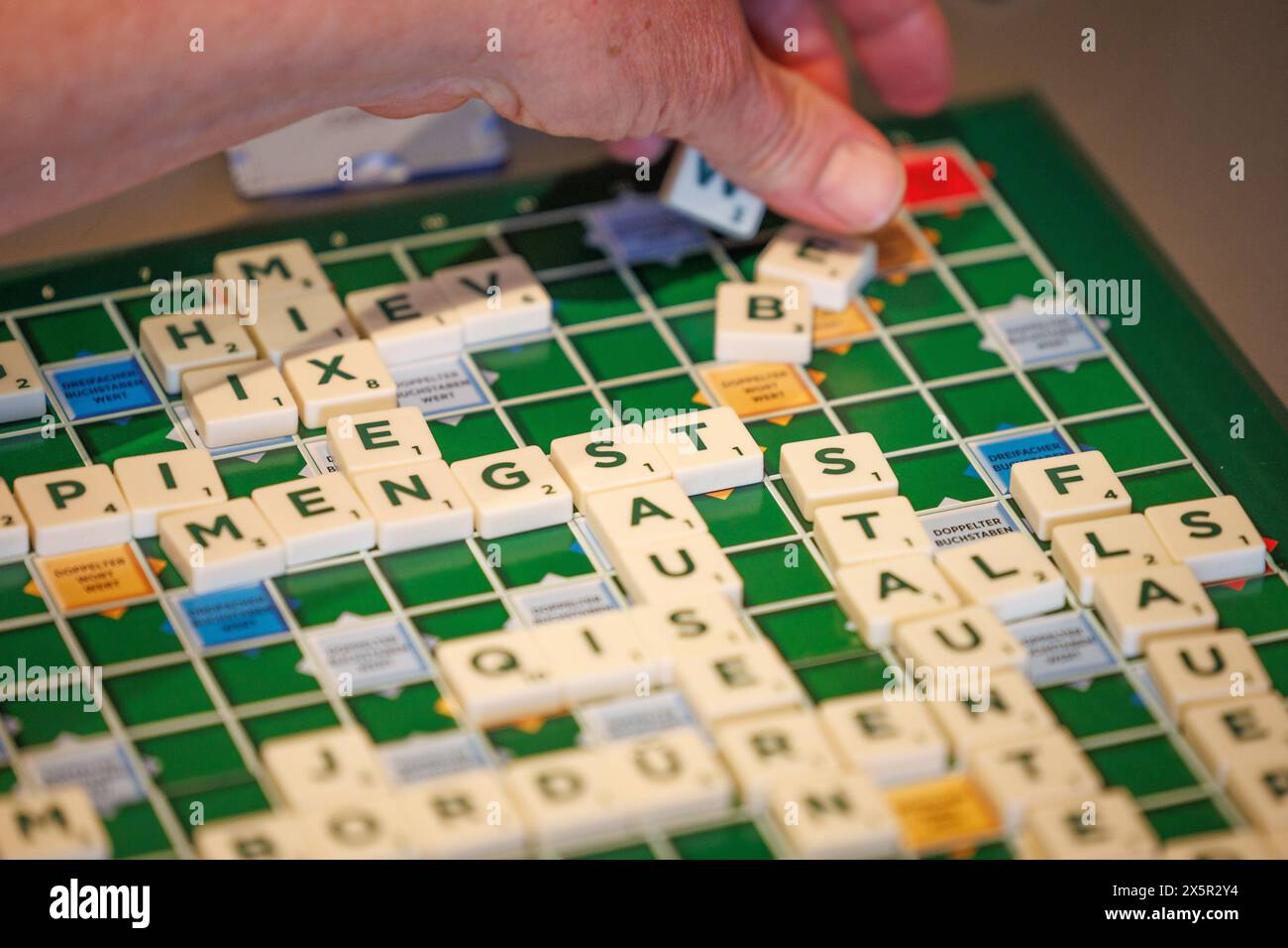 Minden, Germany. 10th May, 2024. A Scrabble player sits at a table at ...