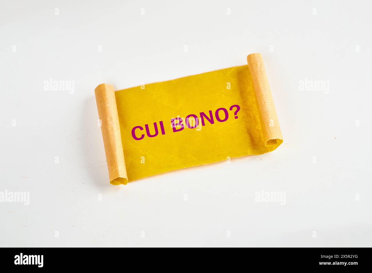 CUI BONO (to whose benefit) question on yellow torn paper Stock Photo ...