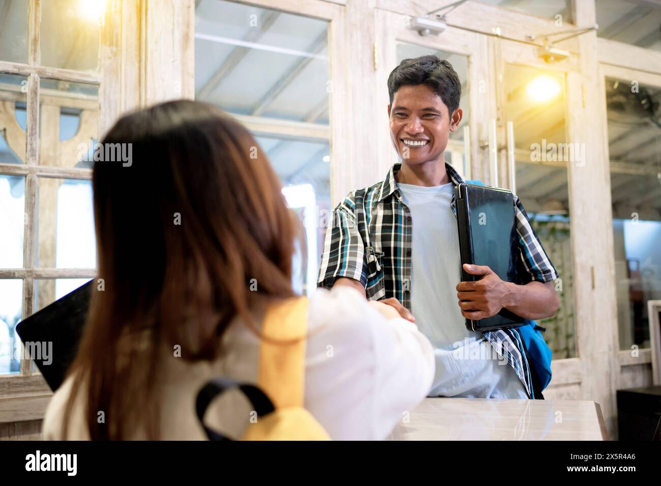 Indonesian male office worker handshake with female client on a meeting ...