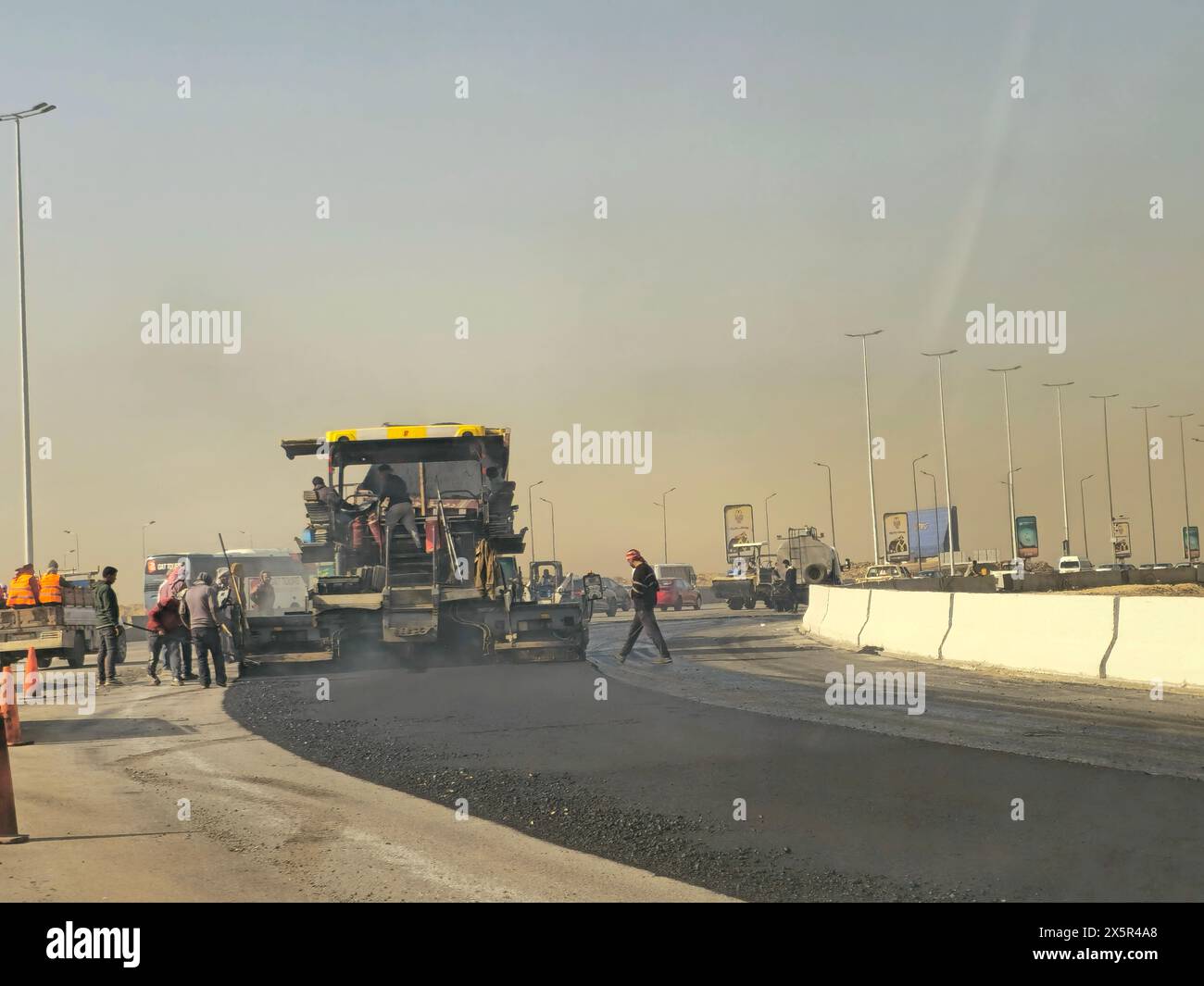 Cairo, Egypt, March 27 2024: process of paving a road and making ...