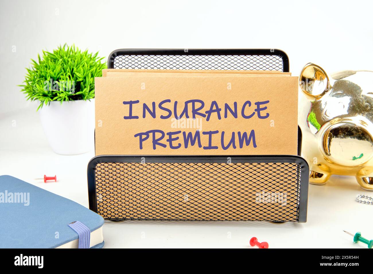 Business concept. INSURANCE PREMIUM text written on the envelope in a ...