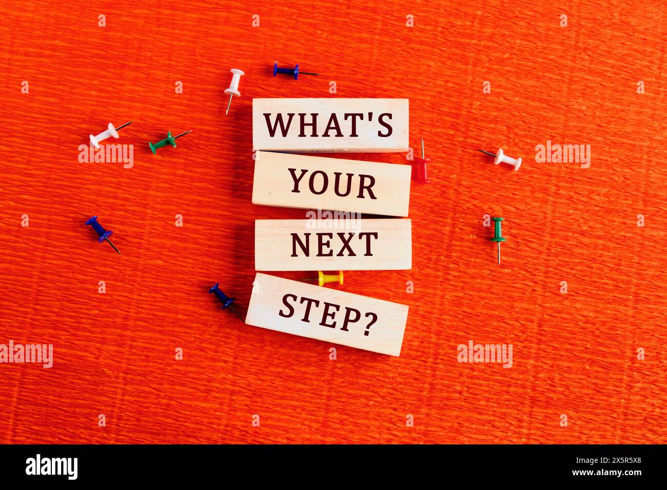 What is your next step symbol on wooden blocks on a red background ...