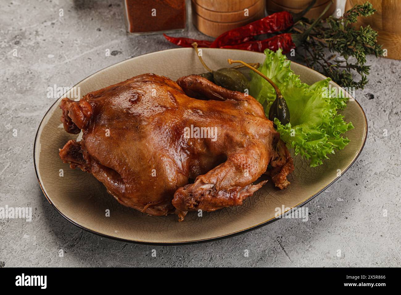 Baked whole small chicken with spices Stock Photo - Alamy