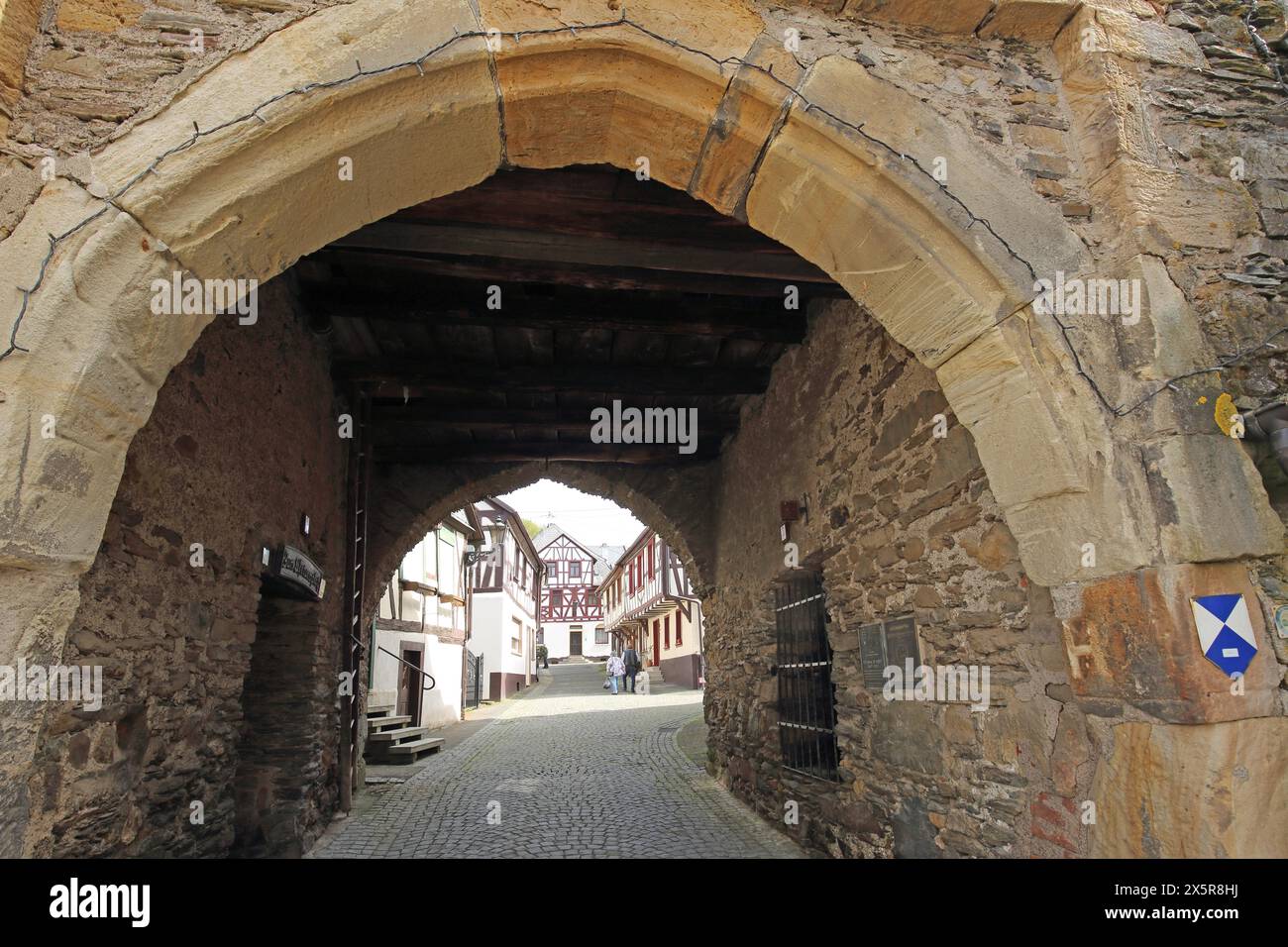 View through historic town gate, clock tower, landmark on clock tower ...