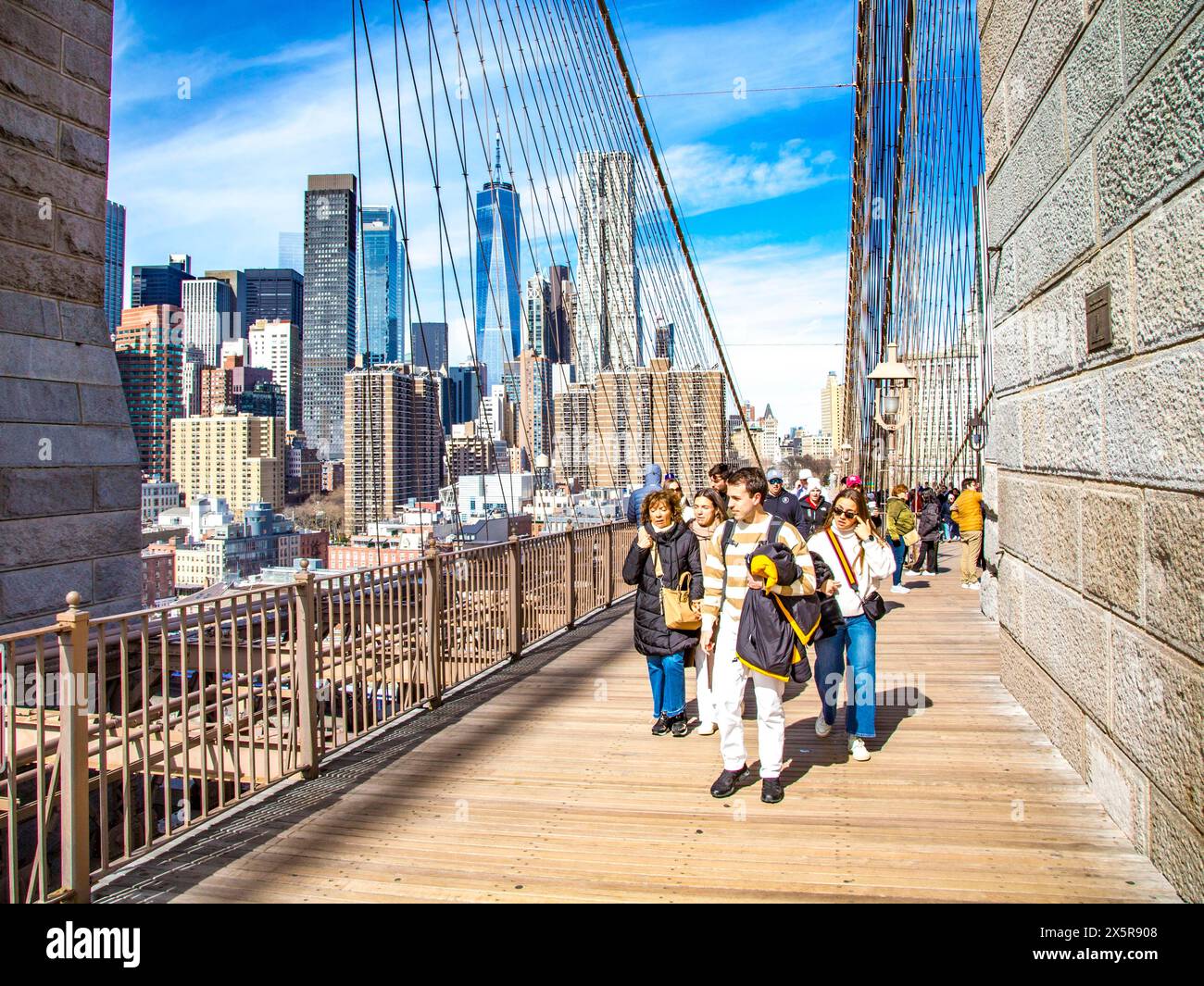 From the footpath over the Brooklyn Bridge, you can see through a ...