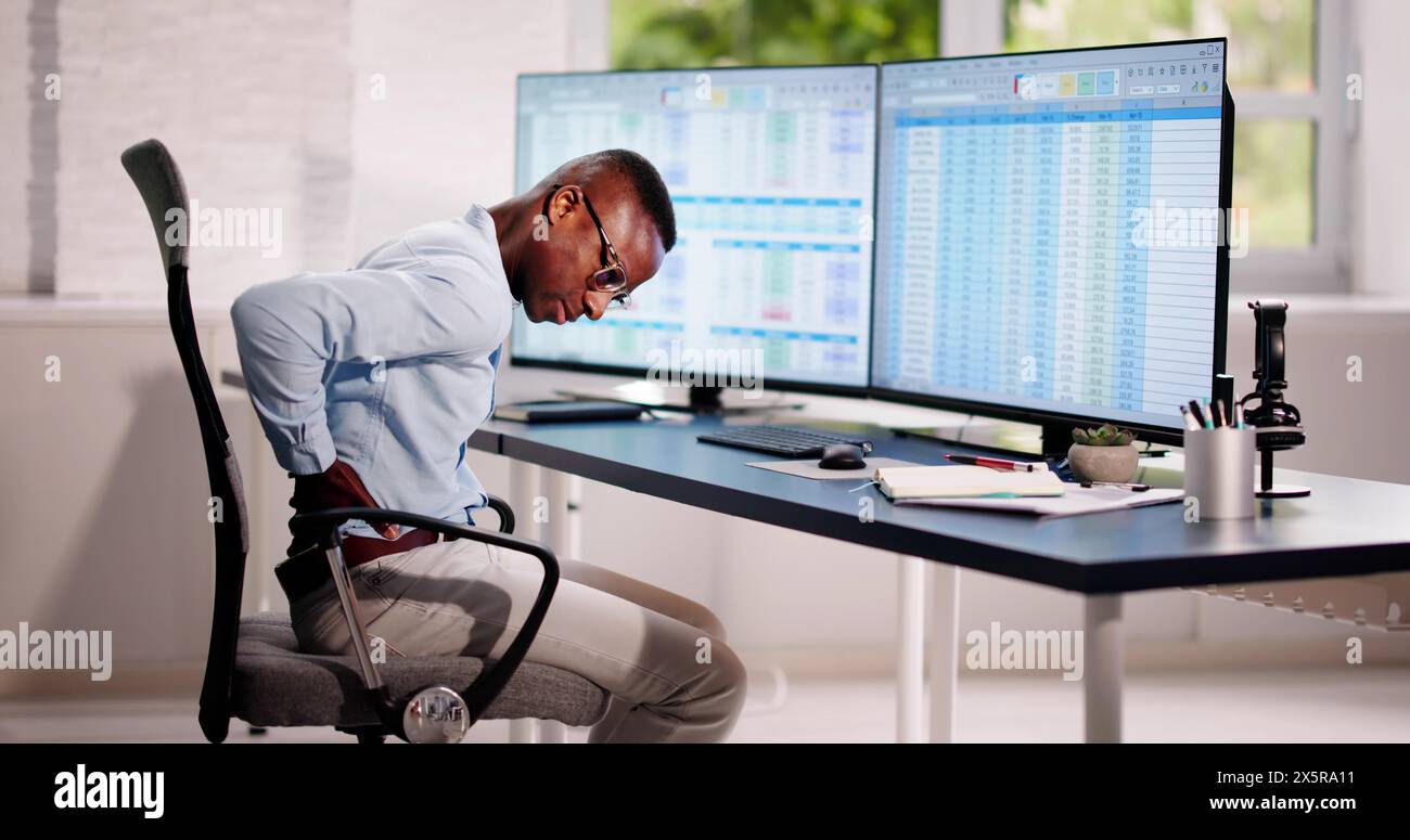 Back Pain Bad Posture Man Sitting In Office Stock Photo - Alamy