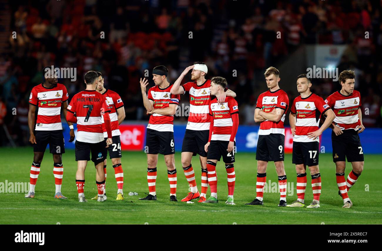Doncaster players stand dejected following the Sky Bet League Two play ...