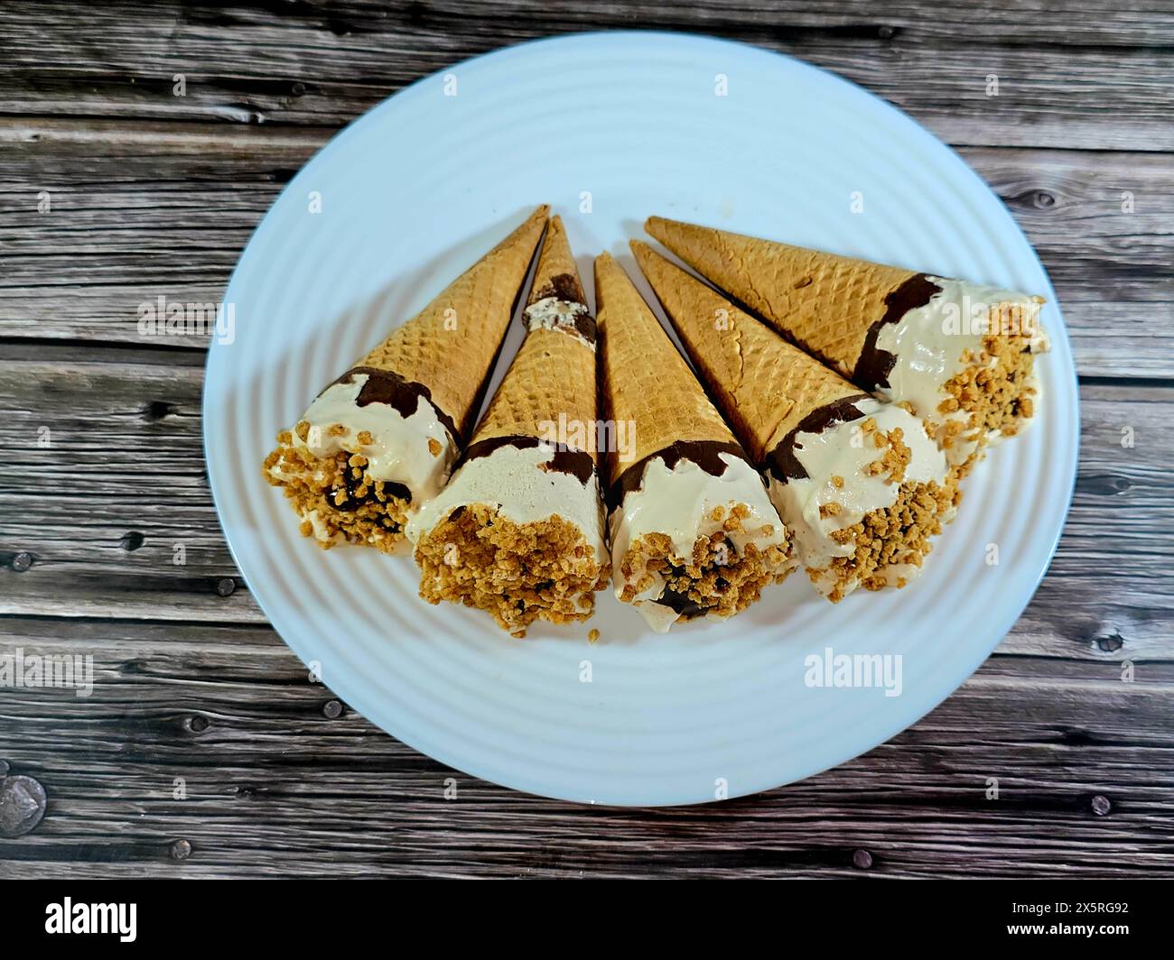 Caramelized Biscuit Ice Cream Cone, melting cold ice cream twirl in a ...