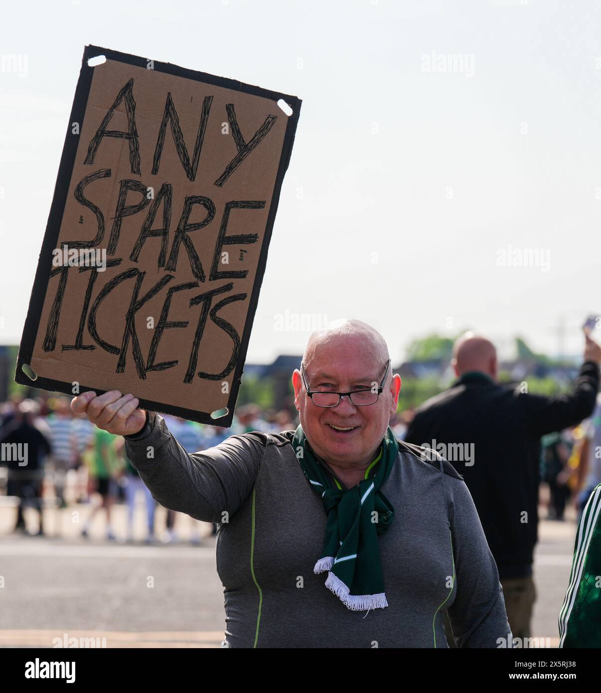 A fan with a sign asking for any spare tickets ahead of the cinch ...