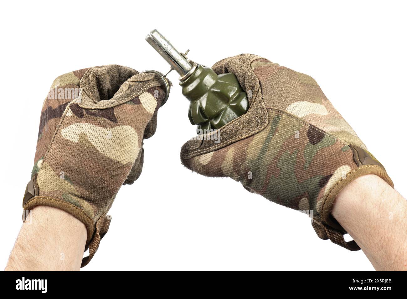 Man`s hand in tactical gloves removes safety pin of old green shrapnel ...
