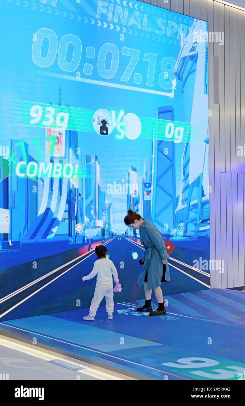 SHANGHAI, CHINA - MAY 9, 2024 - A child plays a 5G smart racing car ...