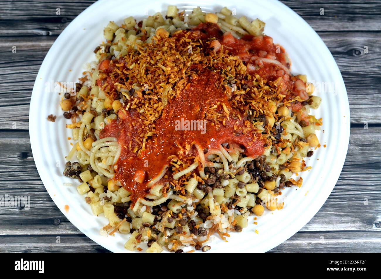 Egyptian cuisine of Koshary, a popular street food made of rice ...