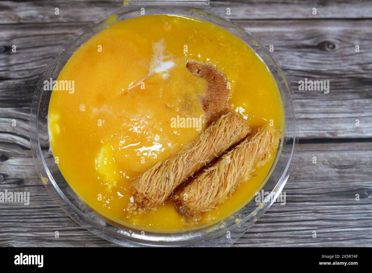 A sweet mixture dessert of rice pudding, milk cream qishta, basbousa ...