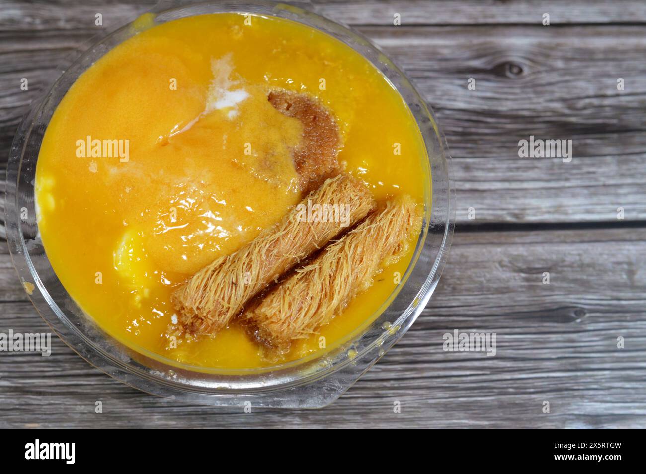 A sweet mixture dessert of rice pudding, milk cream qishta, basbousa ...