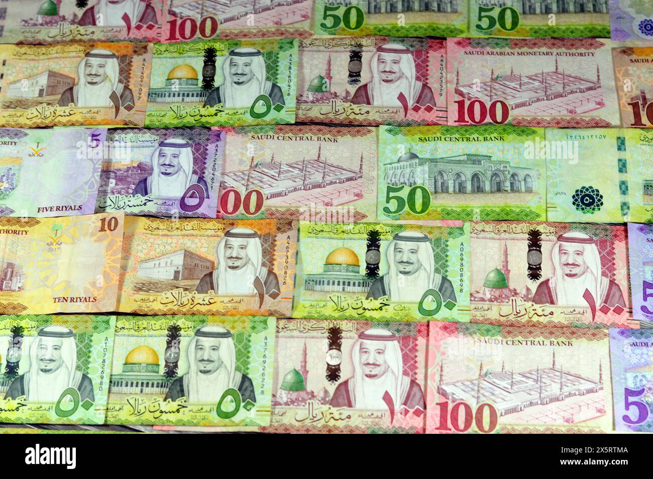 Background of Saudi Arabia money banknotes bill of different values ...