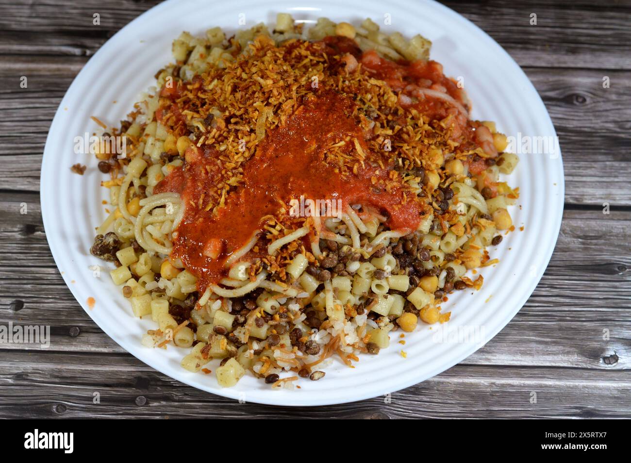 Egyptian cuisine of Koshary, a popular street food made of rice ...