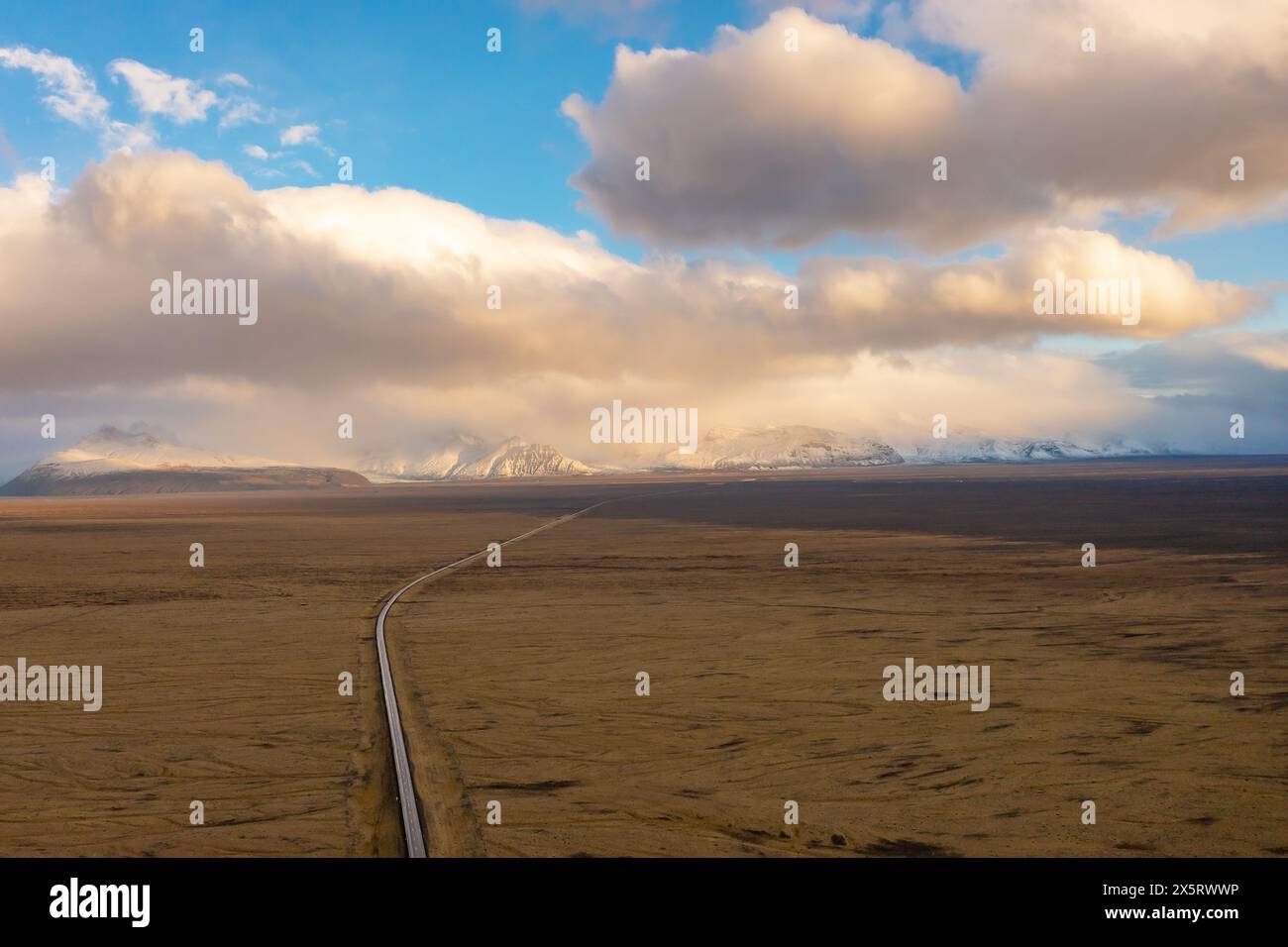 Road through valley of volcanic lava, covered with ash and sand. Sunset ...