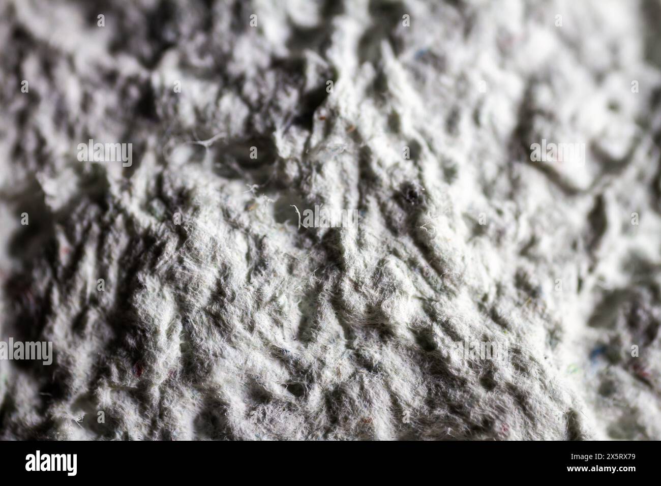 Extreme close up of old gray handmade paper mache with a structure and ...