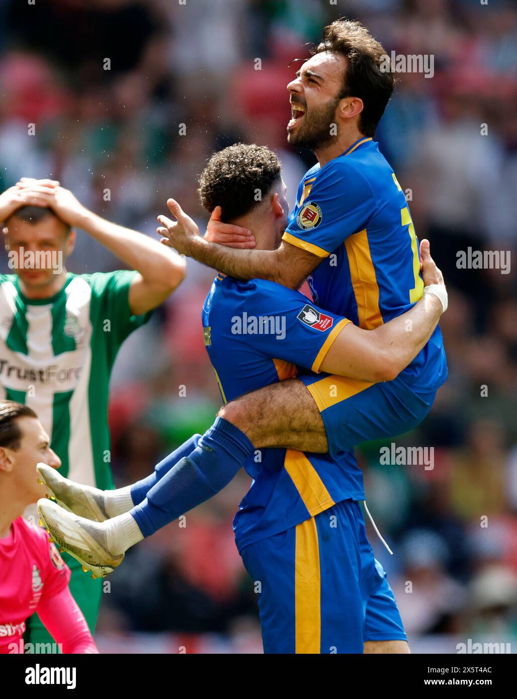 Romford's Hassan Nalbant (left) celebrates scoring their side's first ...