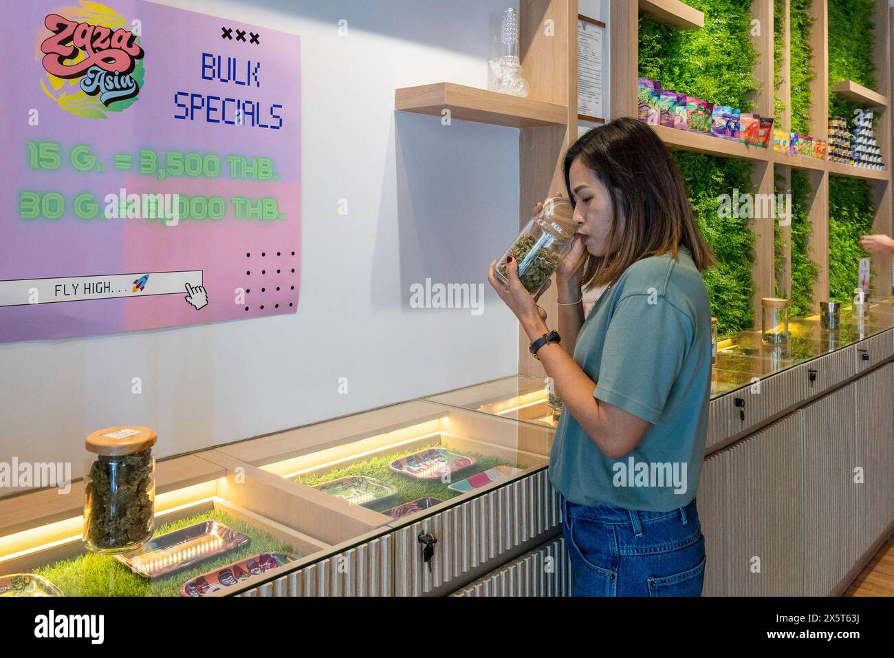 Bangkok, Thailand. 10th May, 2024. An Asia customer is seen smelling inside a cannabis pot, at ...