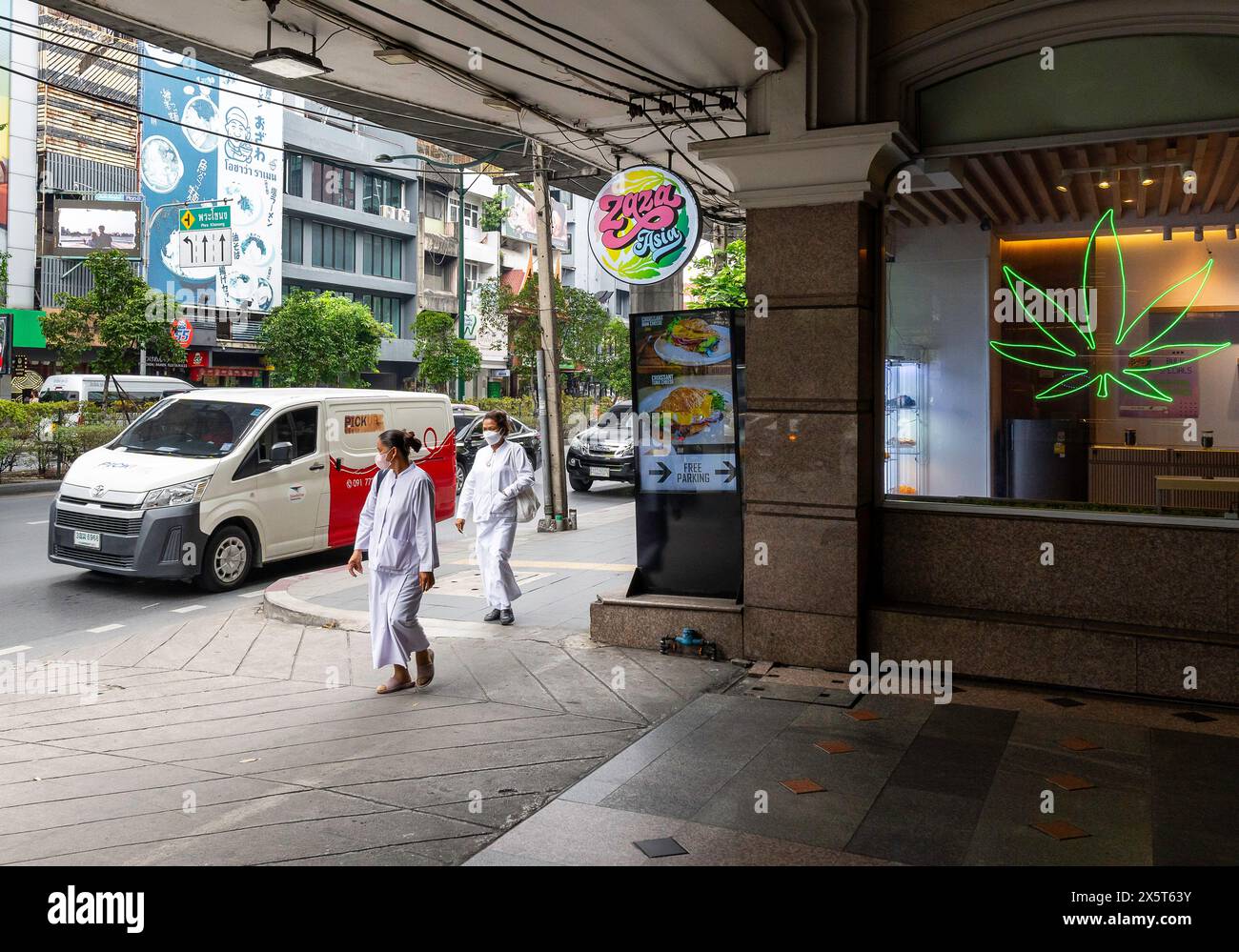 Bangkok, Thailand. 10th May, 2024. Female monks are seen passing in front of ZaZa Asia Cannabis ...