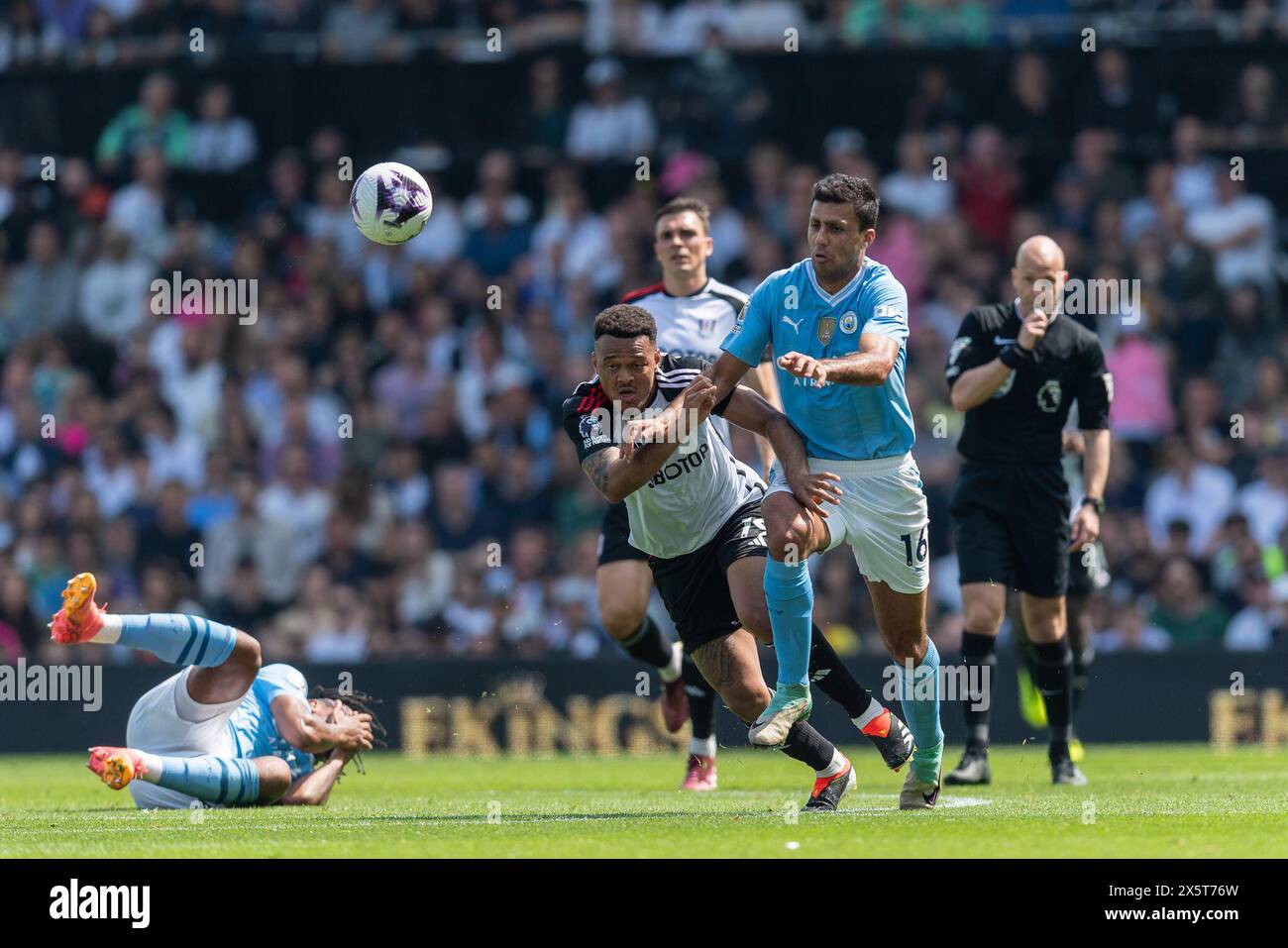 Rodrigo Muniz of Fulham (in white) is fouled by Rodri of Manchester ...