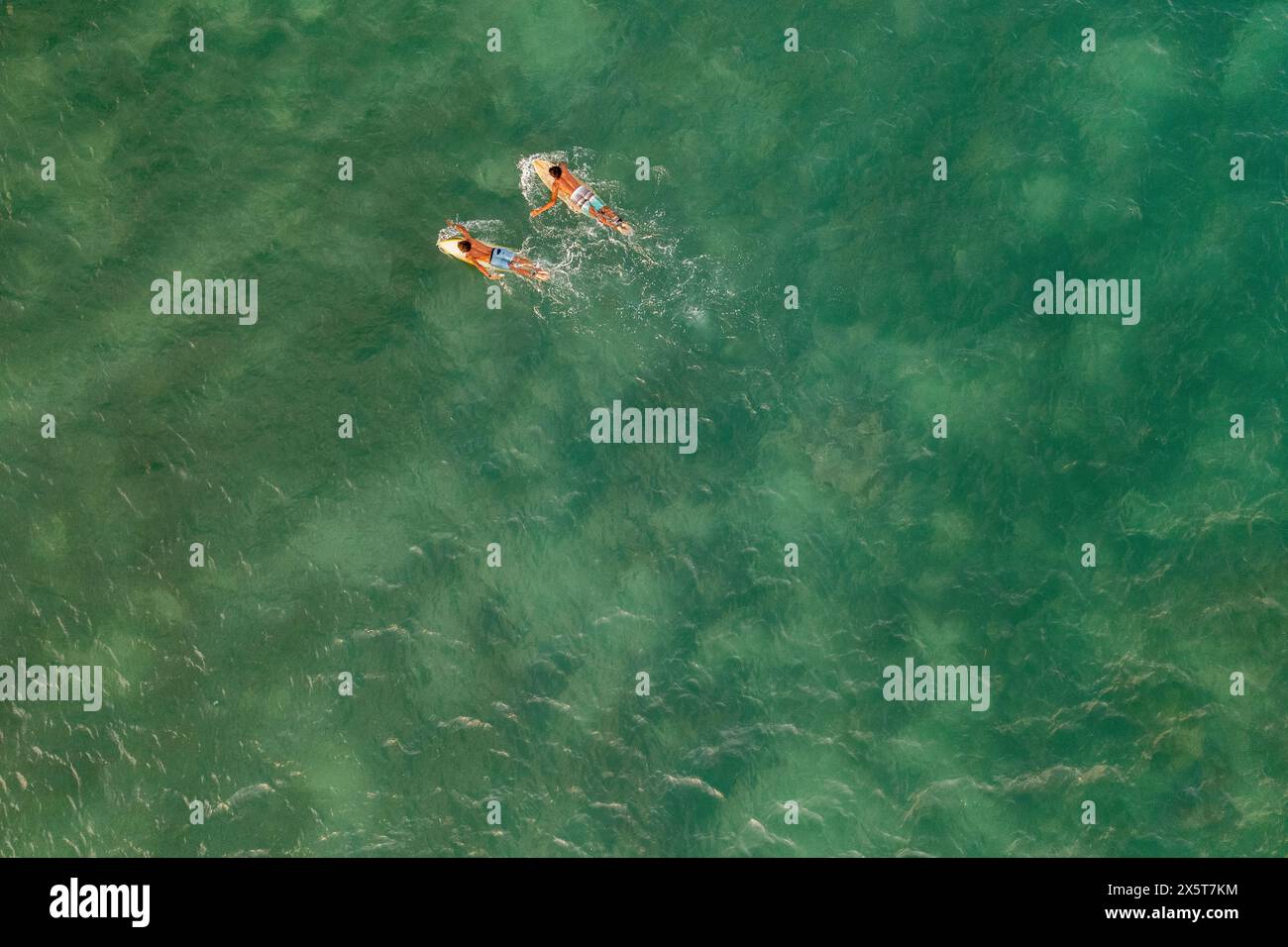 Indonesia, Lombok, Aerial view of men surfing in sea Stock Photo - Alamy