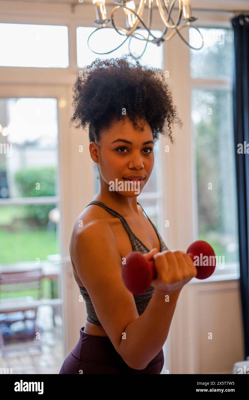 Young woman exercising at home Stock Photo - Alamy