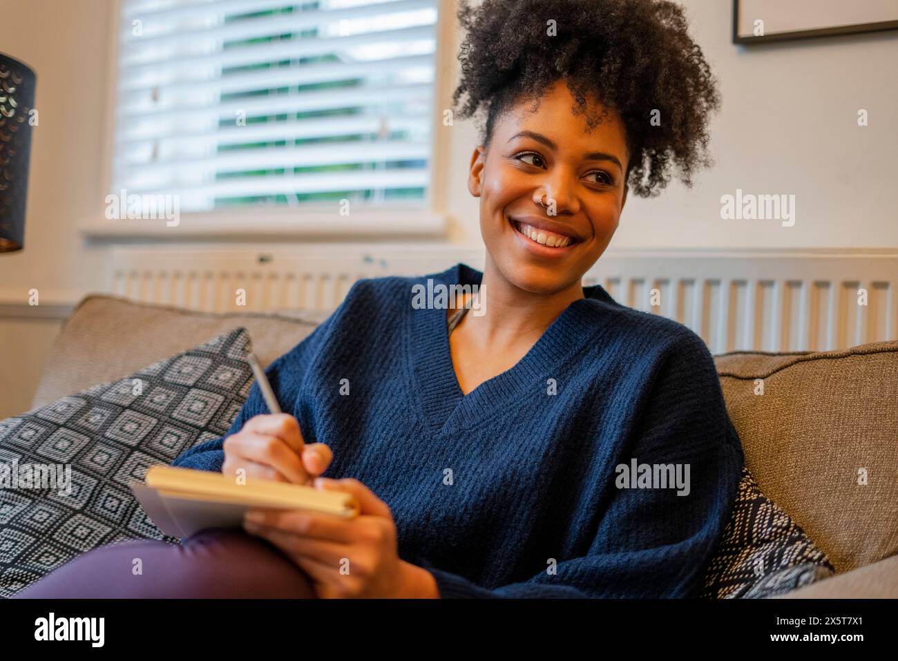 Young african woman writing in hi-res stock photography and images - Alamy