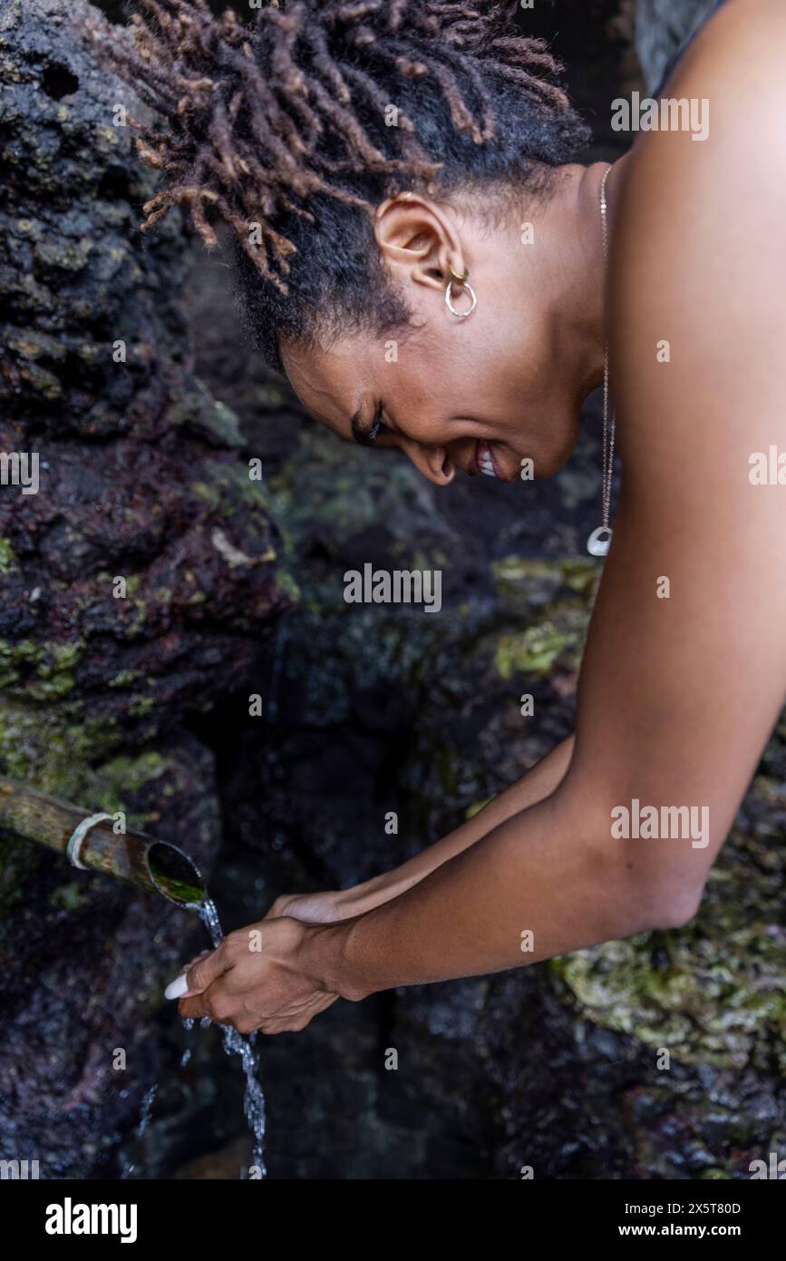 Woman taking water from drinking fountain Stock Photo - Alamy