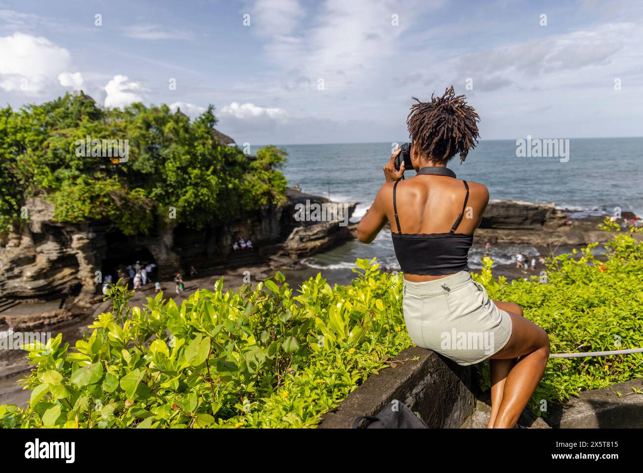 Indonesia, Bali, Female tourist photographing sea from observation ...
